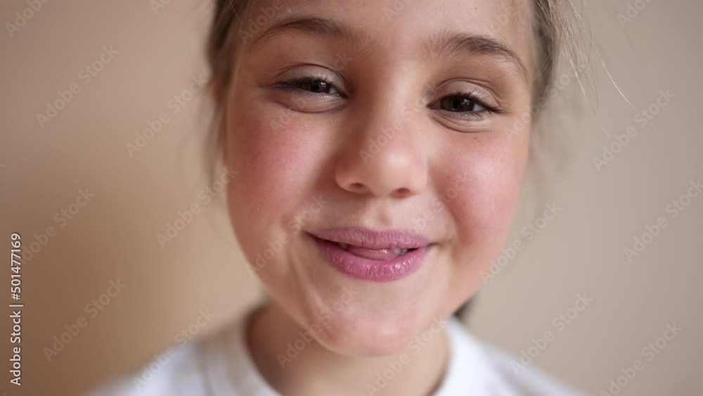 little girl smiling. portrait child girl daughter a close up looking at ...