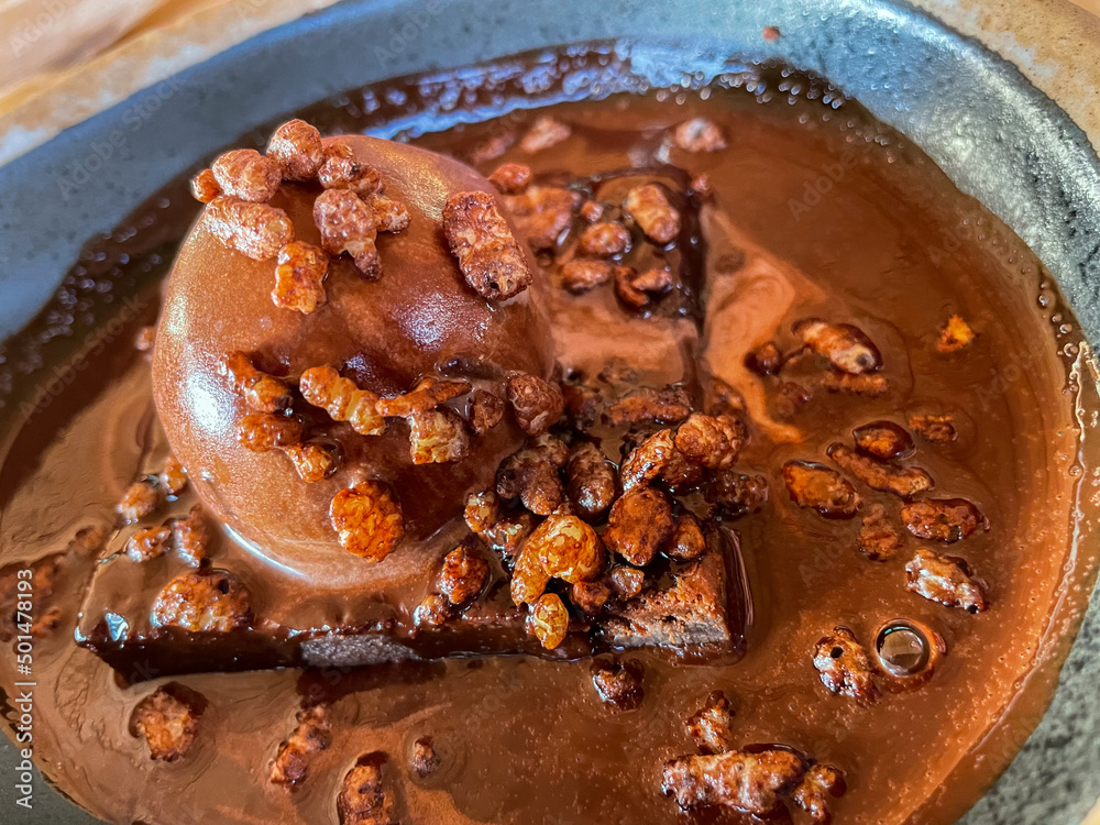 Detail of puffed rice decorating a chocolate dessert. Brownie piece in ...