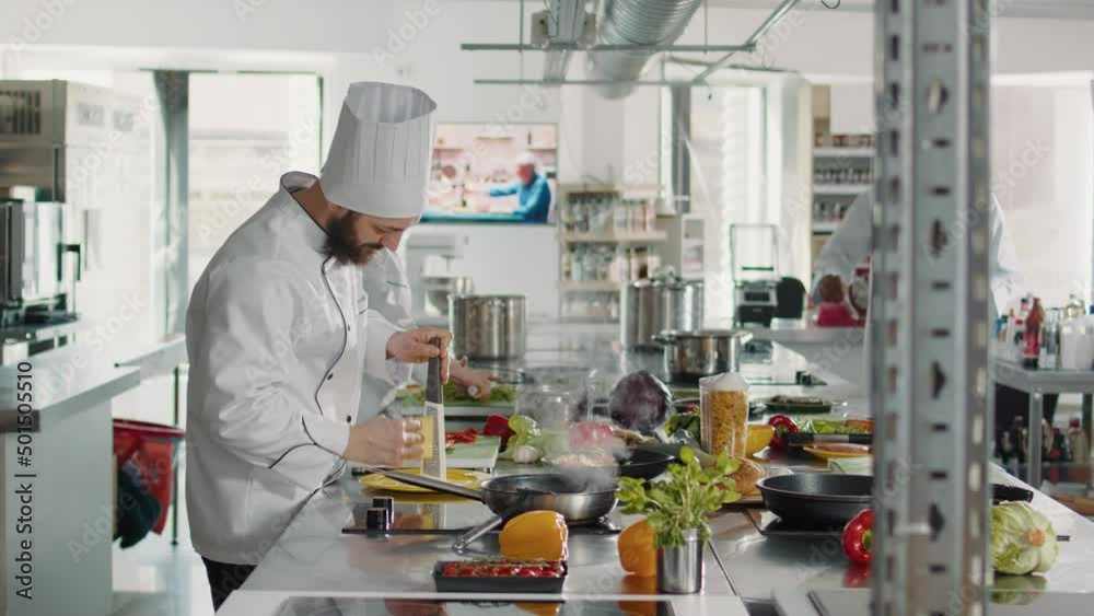 Professional cook using grater to make shredded cheese for italian food ...
