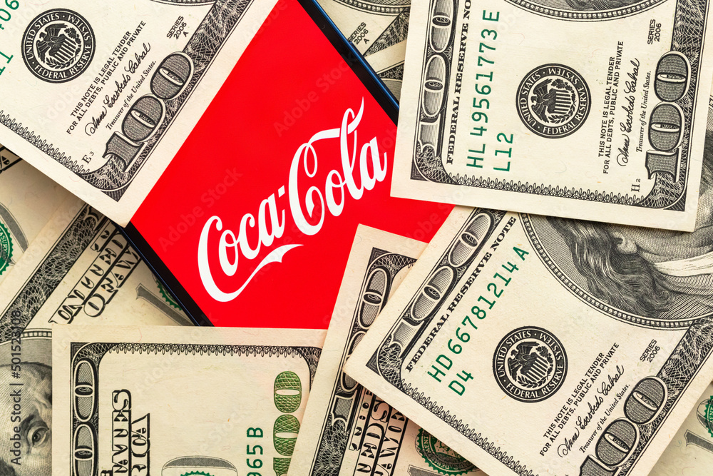 Coca-cola stock market price. Logo close-up view and dollar money ...
