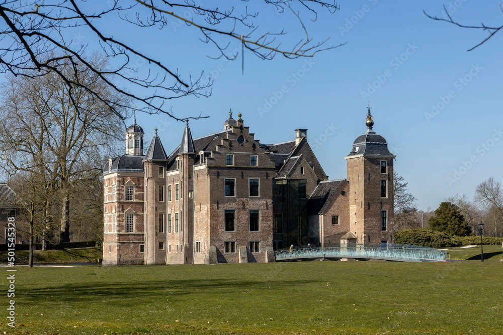 Clearing meadow with brightly lit brick exterior facade of the Ruurlo ...