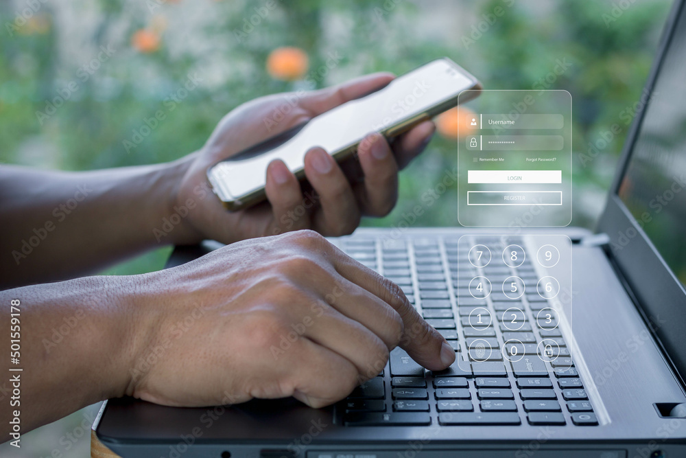 Asian businessman using the smart mobile phone to access on phone with laptop for validate ...