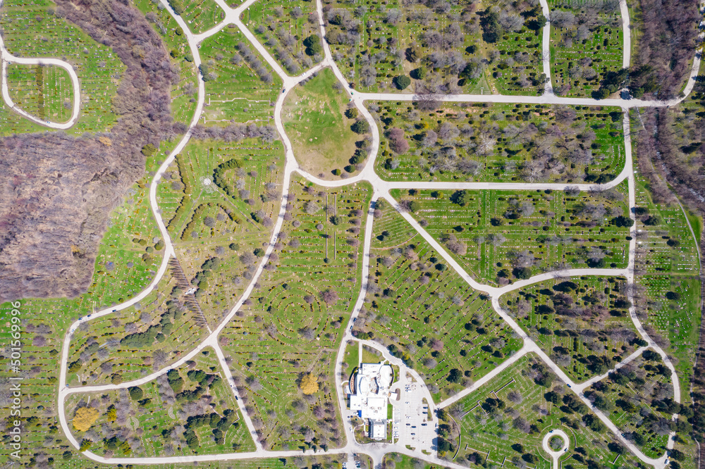 Aerial top very high view of modern cemetery at the city. Small ...