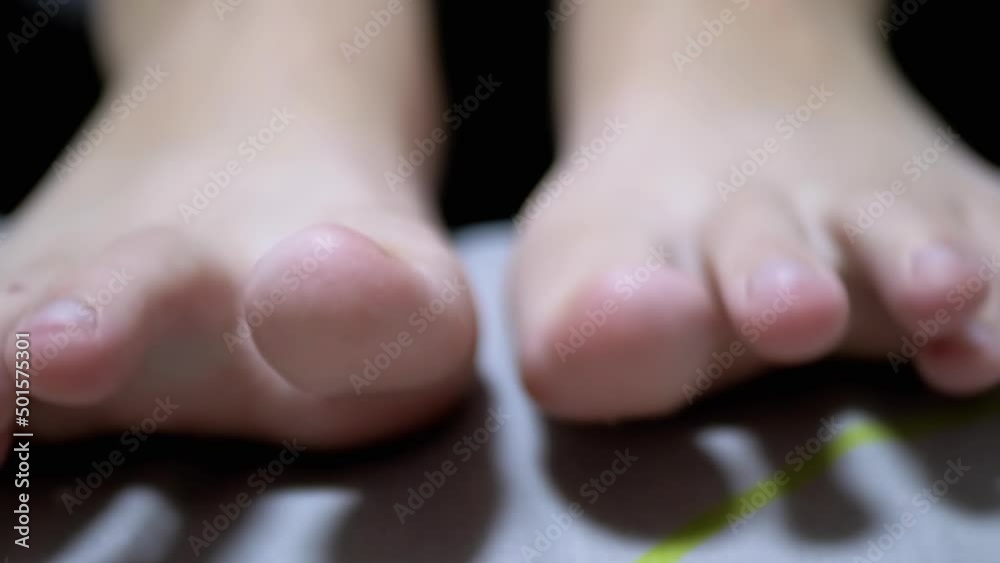 Close-up Tired Child Wiggles his Toes while Lying on the Bed in Room ...