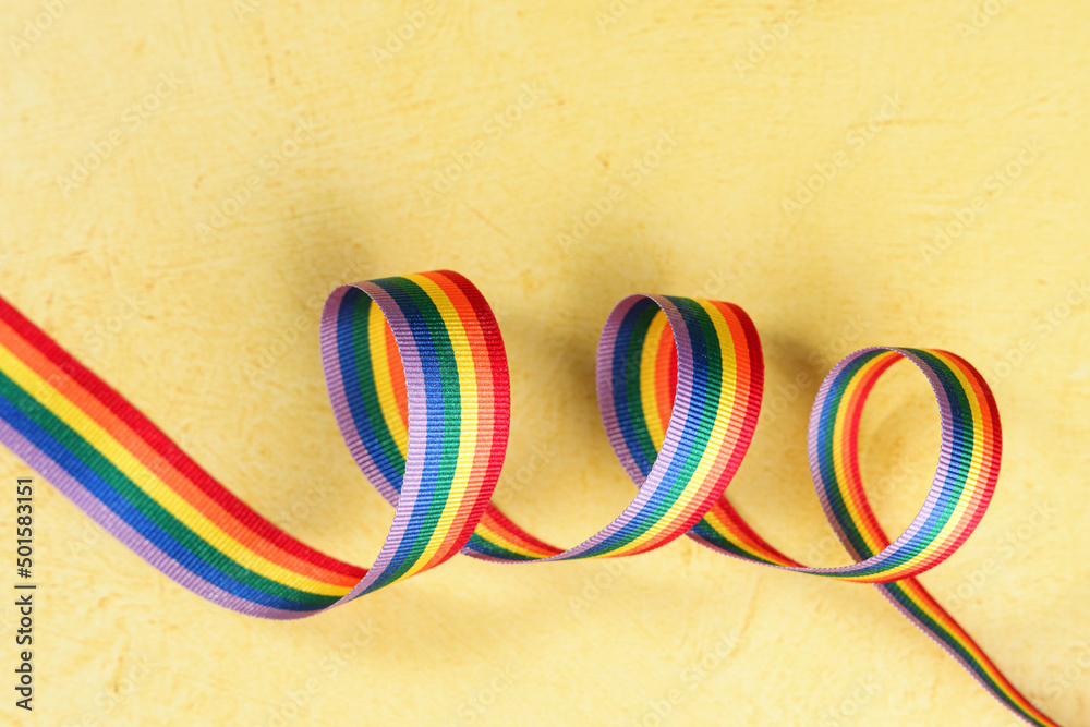 LGBT rainbow ribbon pride symbol. Yellow background Stock Photo | Adobe ...