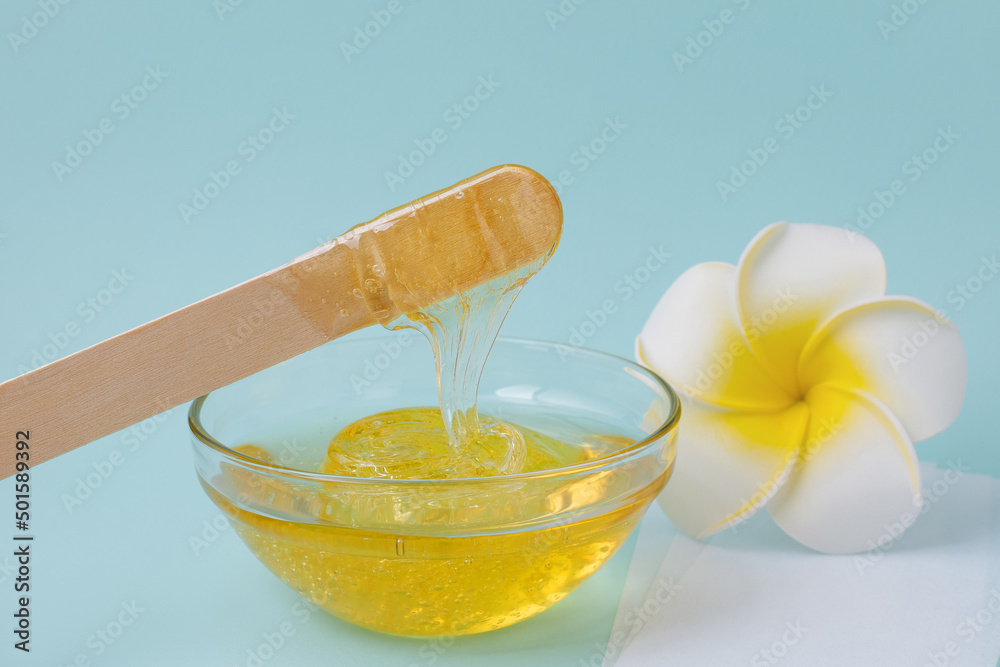Liquid yellow sugar paste, wooden spatula, depilatory strips and flower ...