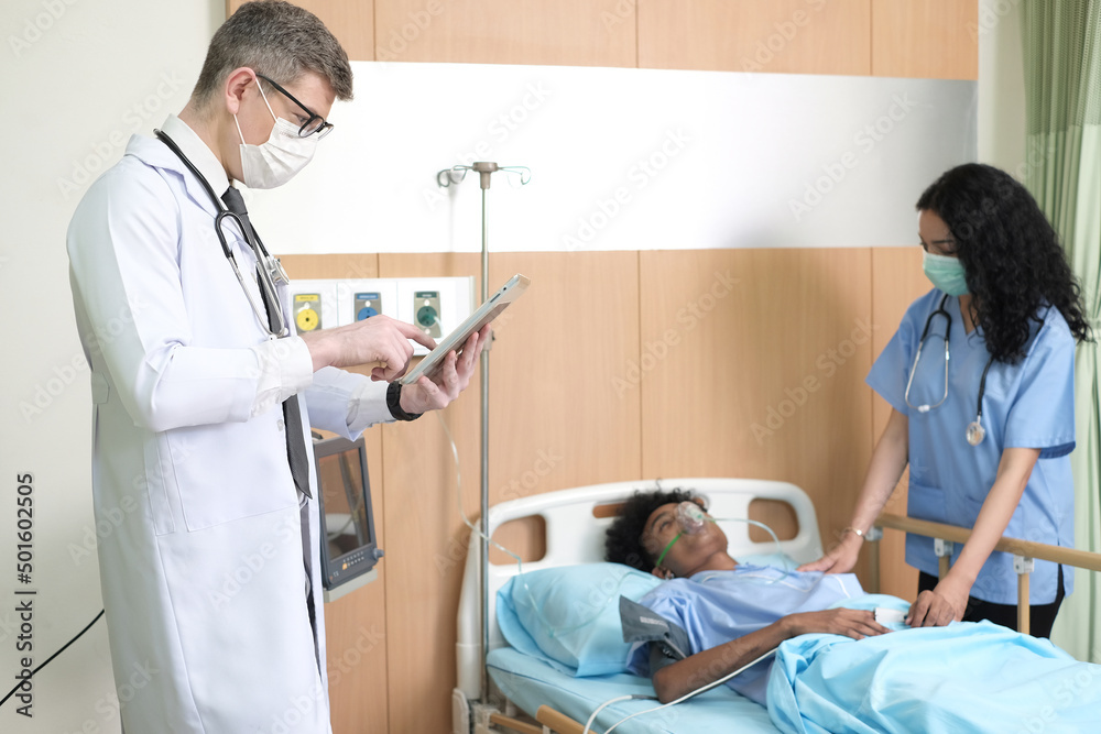 doctor and nurse visiting patient. Intensive care caucasian doctor ...