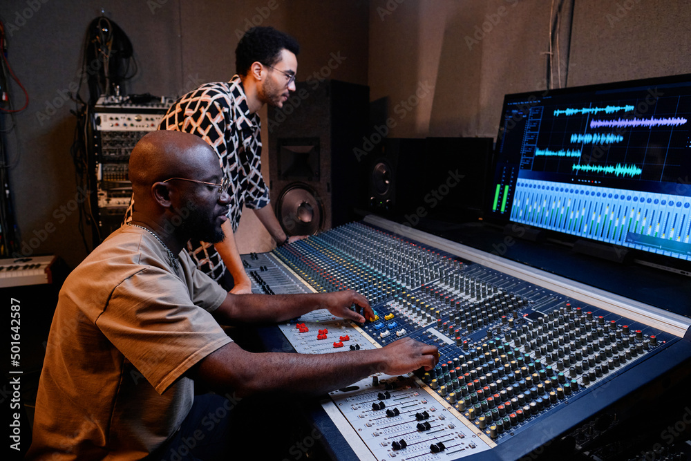 Professional mature African American producer and young musician ...