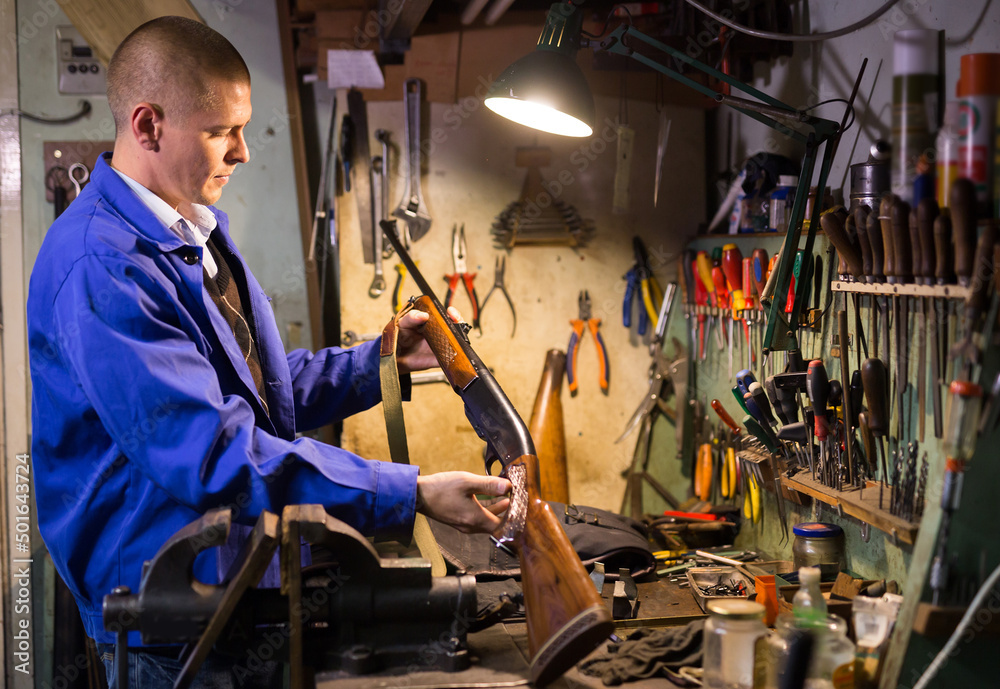 Gunsmith examines and checks appearance of the semi-automatic rifle ...