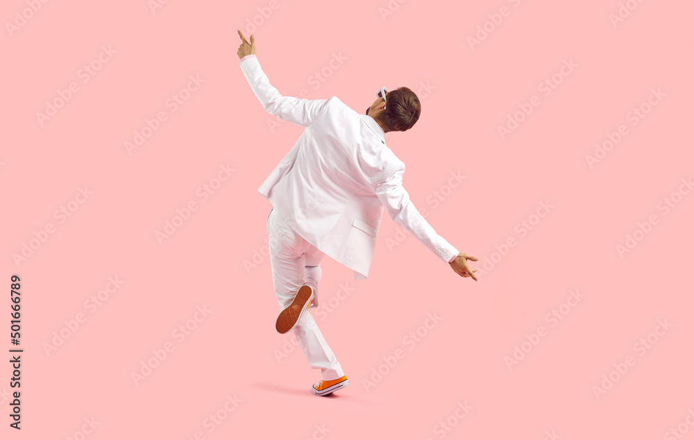 Dance like no one is watching. Full length studio shot of happy elated ...