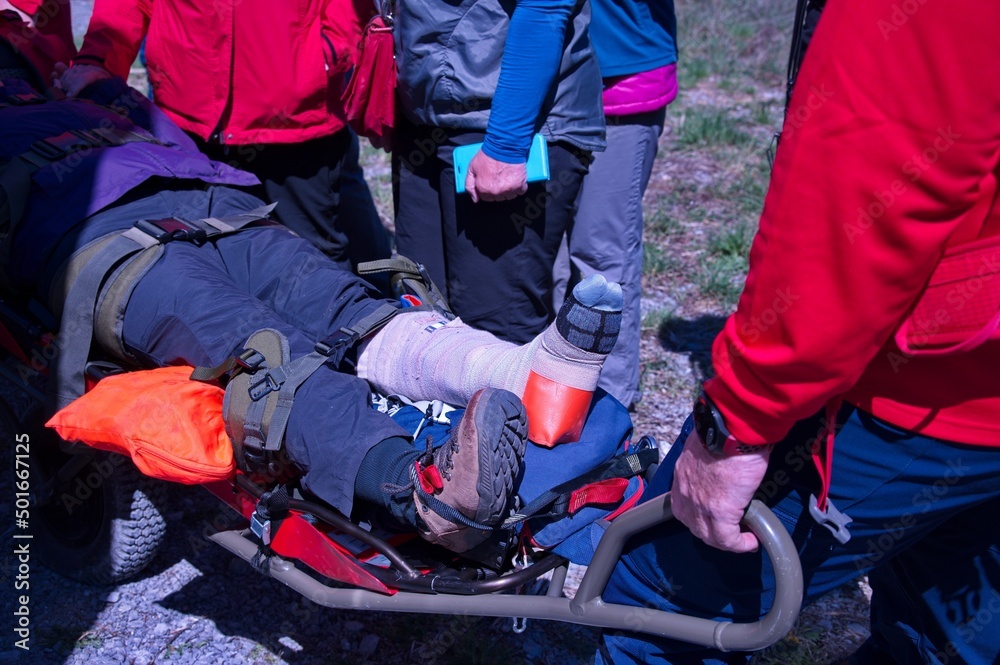 Paramedics from mountain rescue service provide first aid to person ...