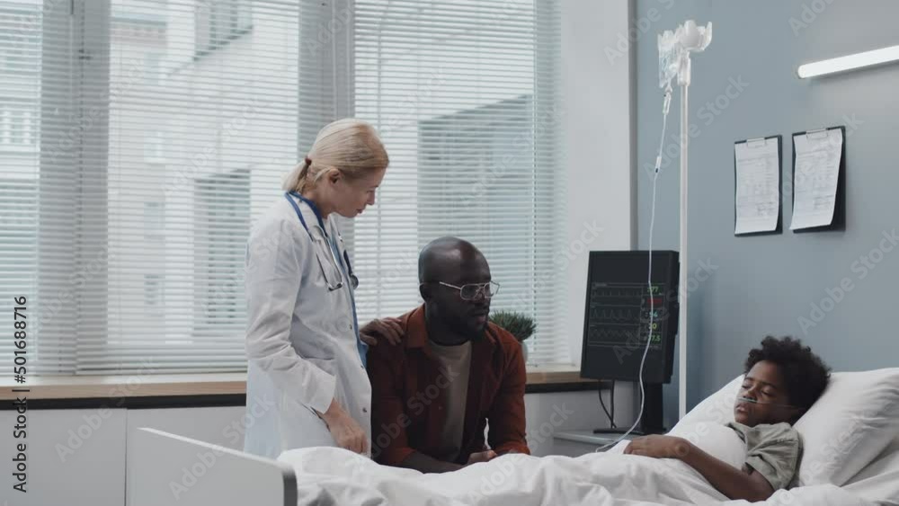 Locked-down of mature Caucasian female doctor coming and reassuring ...