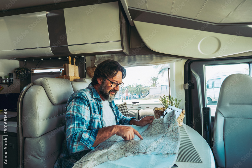Nomadic traveler lifestyle adult mature man inside a camper van ...