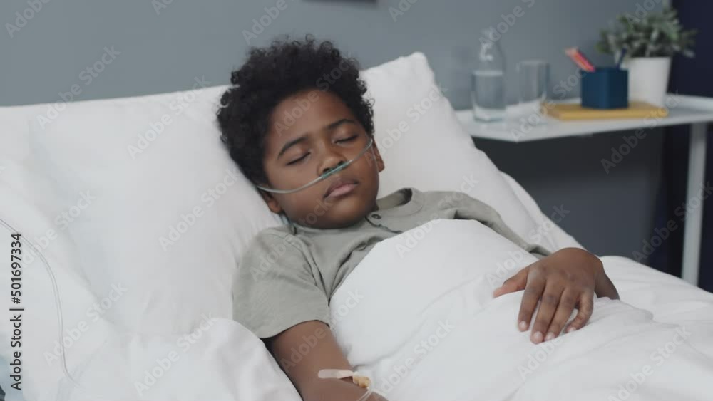 Tracking out of nine-year-old unconscious African American boy lying in ...