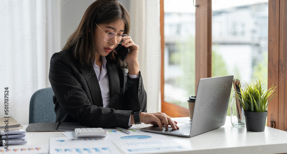 Young accountant with smartphone to call marketing consultants and ...