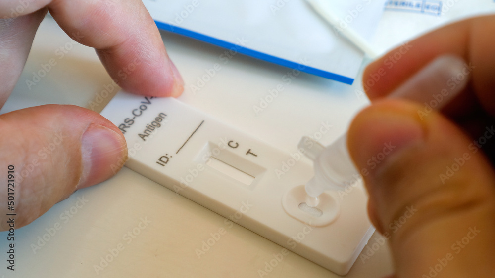 Man hands do four drops of liquid to perform fast coronavirus atk test ...