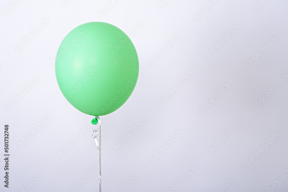 one minimal green balloon on white background, copy space, element of ...
