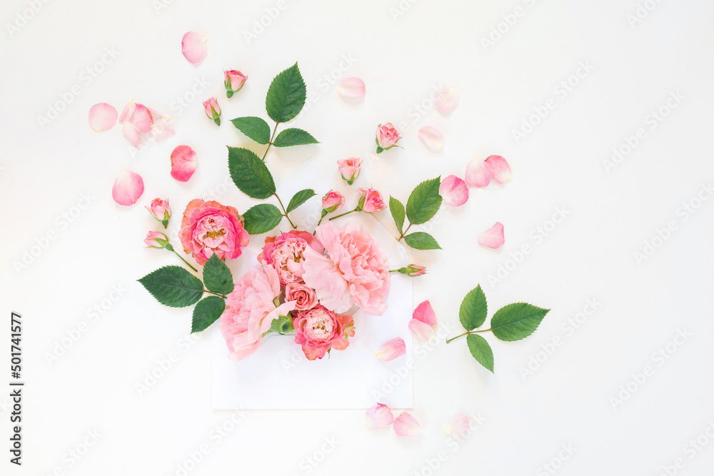 Floral composition made of flowers buds, petals and green leaves in ...