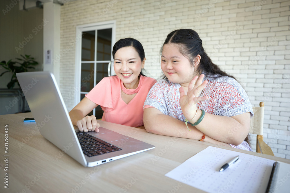 down syndrome teenage girl and her teacher studying how to use laptop ...
