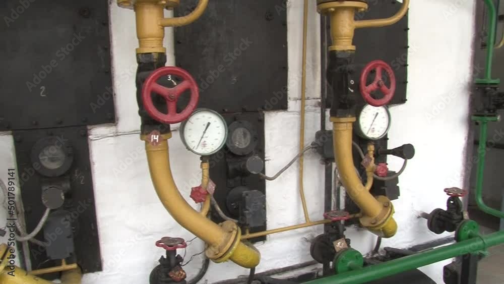 Boiler room with pipes, valves and sensors.Manometer, pipes and faucet ...