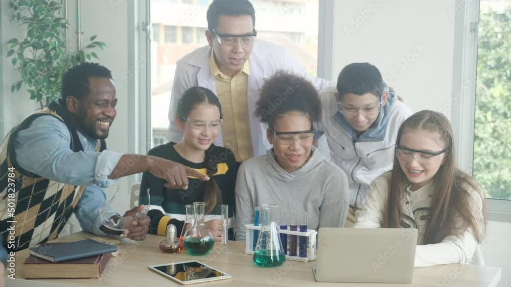 Young teacher teaching group student about science and explaining ...