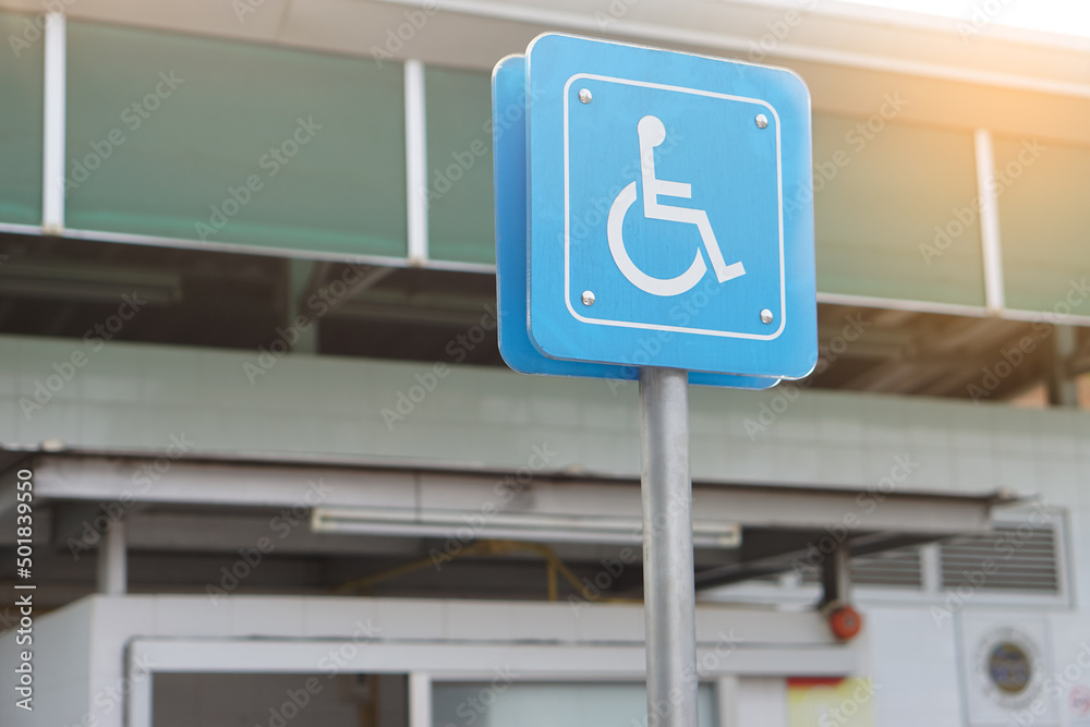 Blue sign with symbol of person sit on wheelchair. Parking for ...