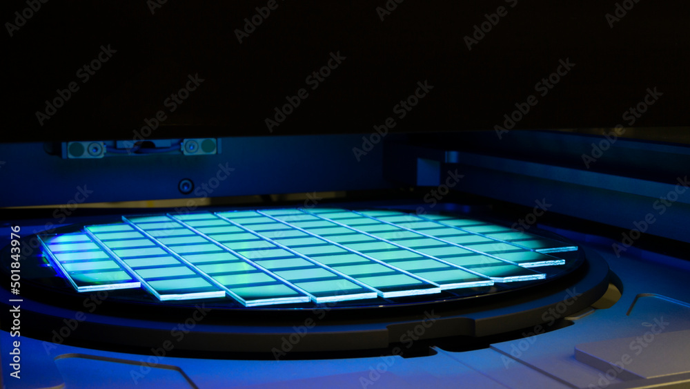 Silicon wafer with chips in UV lighting. Neon. Ultraviolet Lithography ...