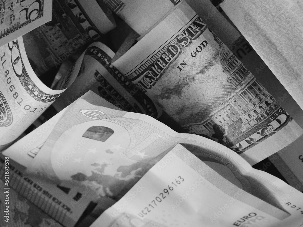 Cash banknotes dollars and euros are mixed up, a close-up shot. Black ...