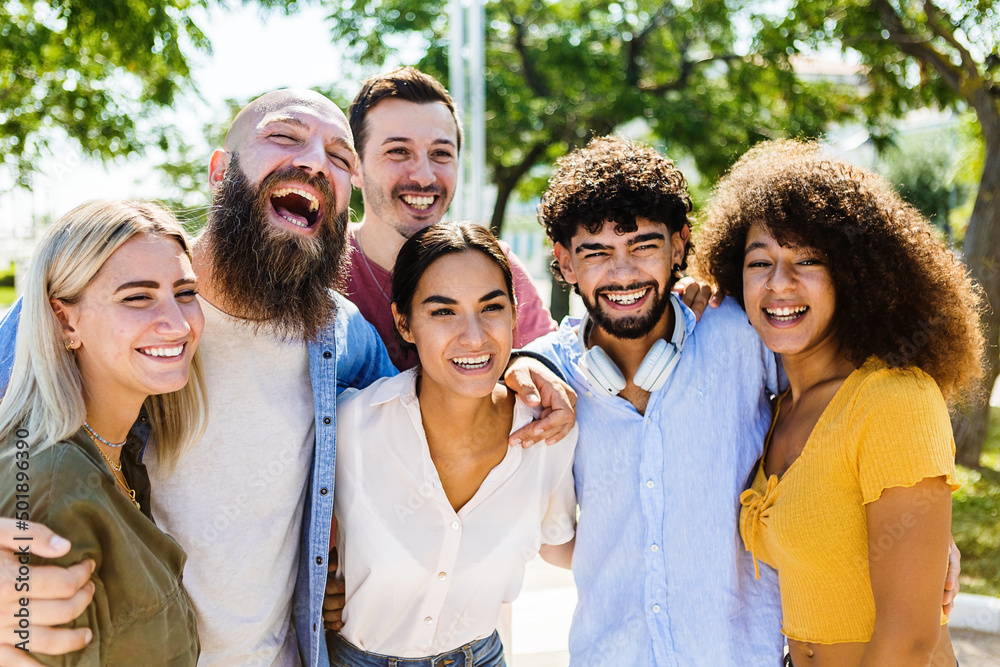 Portrait group of happy multiracial young friends hugging each other ...