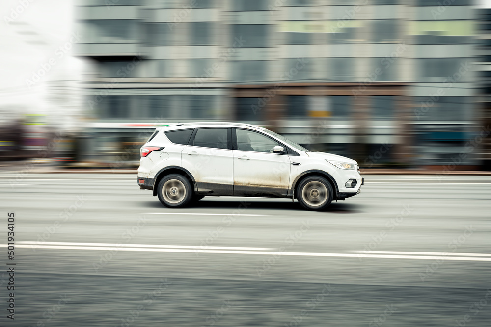 Car driving fast motion on highway, side view. White Ford Kuga SUV ...