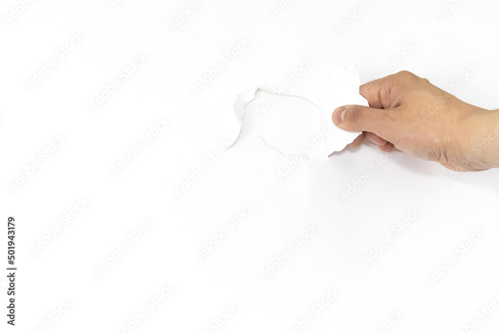 Hand tears off a strip from white paper background. Isolated on white ...