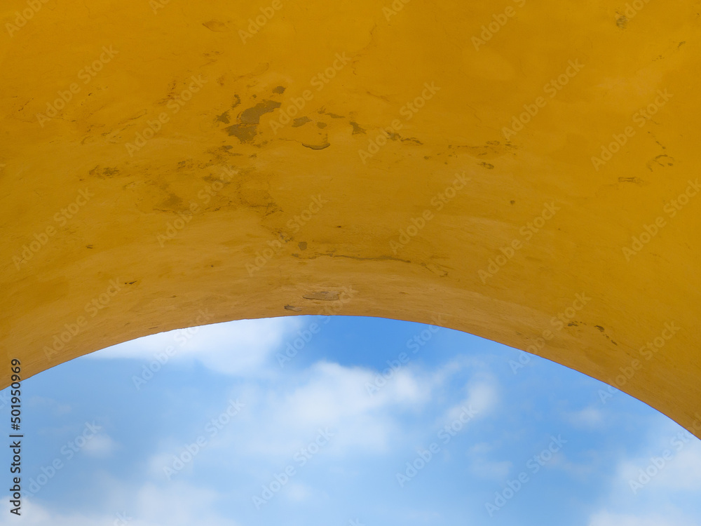 Colorful yellow arch opens into a courtyard inside the El Morro Castle ...