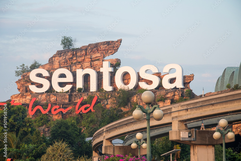The sign of the Sentosa Island surrounded by tropical trees, Singapore ...