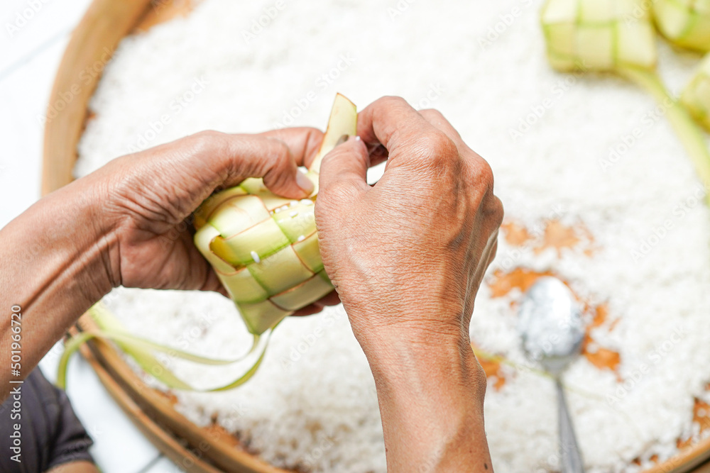 The process of making ketupat is a traditional food during Eid. Put the ...