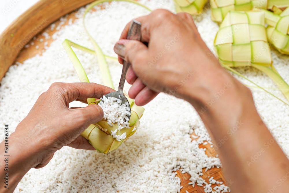 The process of making ketupat is a traditional food during Eid. Put the ...