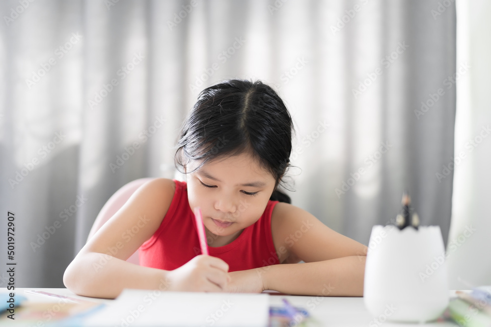 asian child writing or draw on book or kid girl student back to school ...