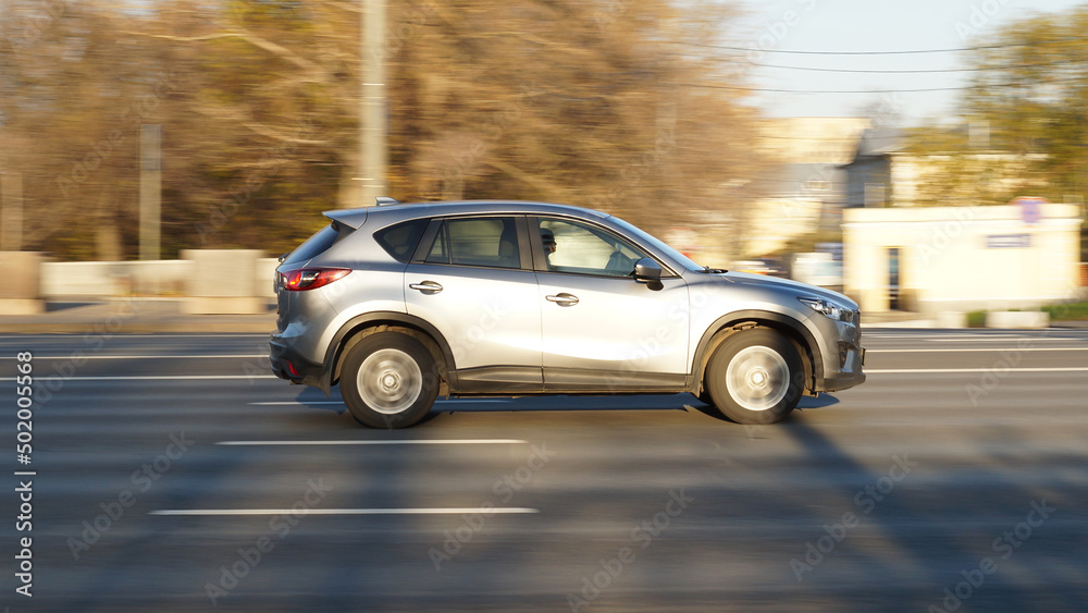 Fast moving silver Mazda CX-5 on speedway road. Overspeed in city ...