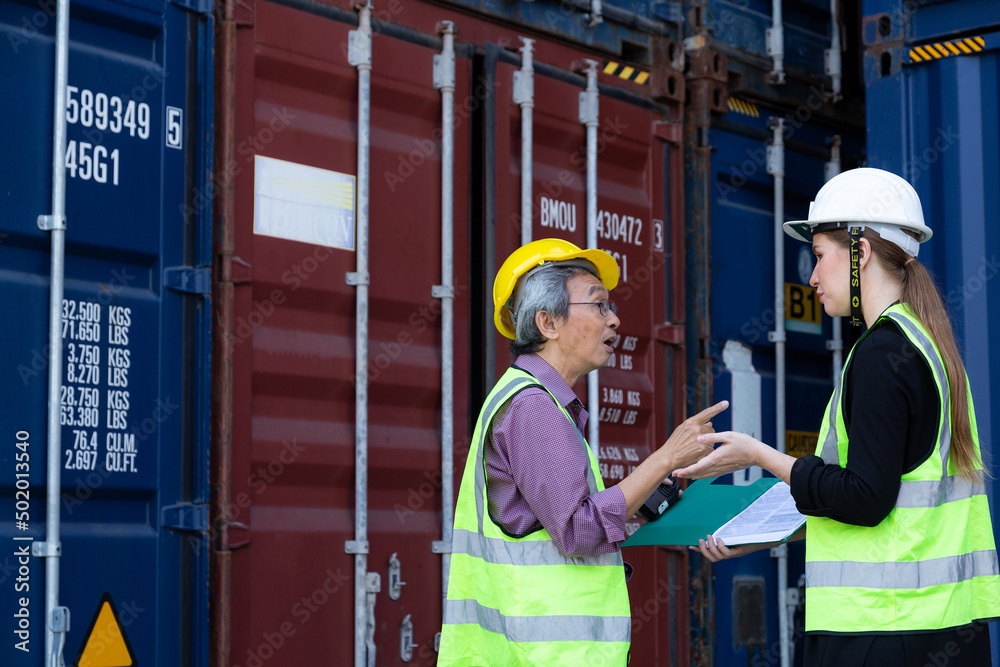 Manager controller woman and logistics man worker wear safety helmets ...