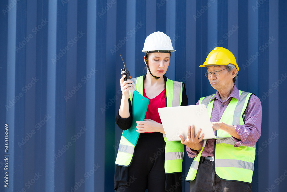 Manager controller woman and logistics man worker wear safety helmets ...