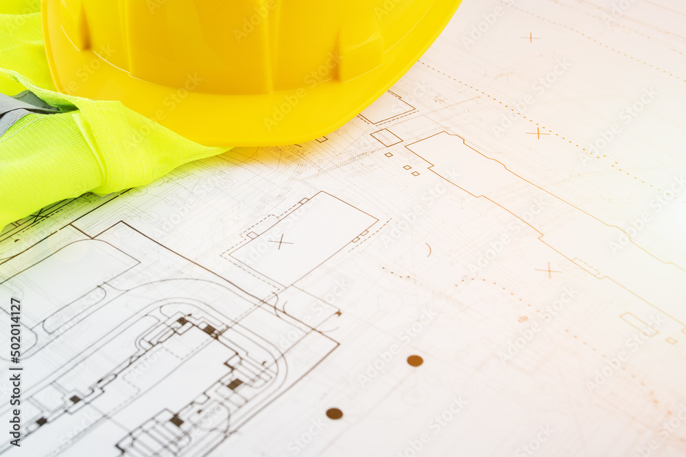 Architecture and construction, builder's hard hat and safety vest on ...
