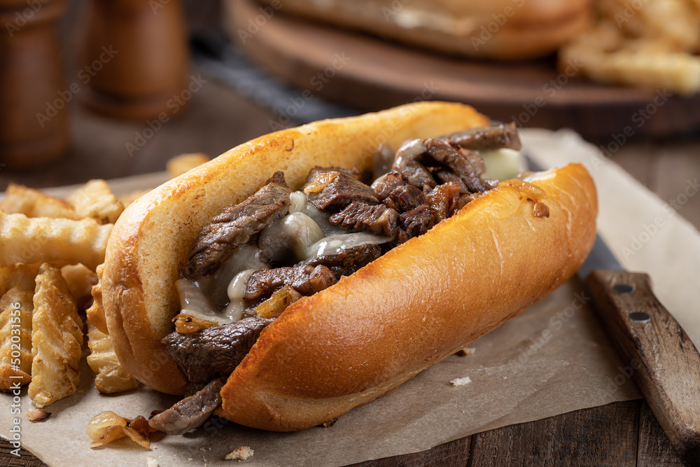 Philly cheesesteak submarine sandwich and french fries Stock Photo ...