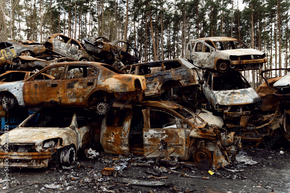 rusty burnt out cars destroyed from rocket explosions. fragments of ...