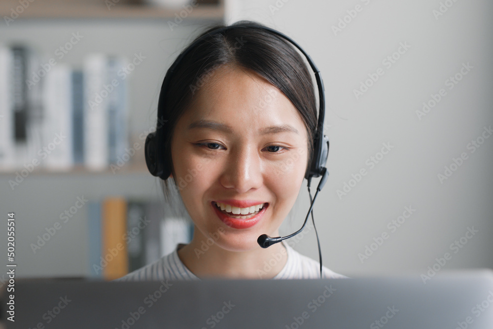 Close up of Young Asian businesswoman wearing headphone, call center ...