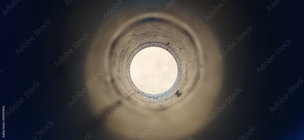 Fotka „Close-up deep endless round large and long concrete pipe hole ...