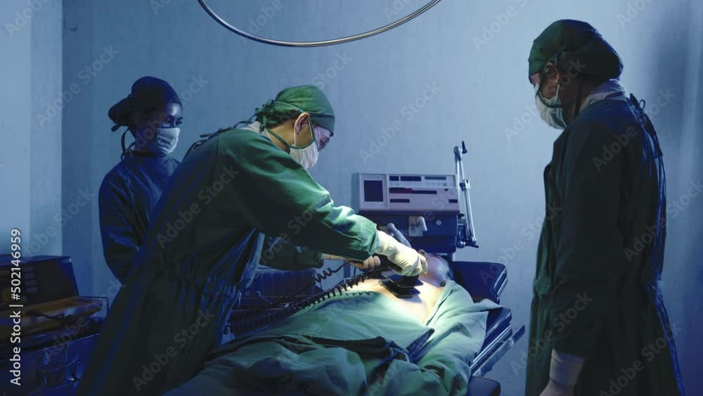 Defibrillation cardiac dysrhythmia, Surgical doctor team performing ...