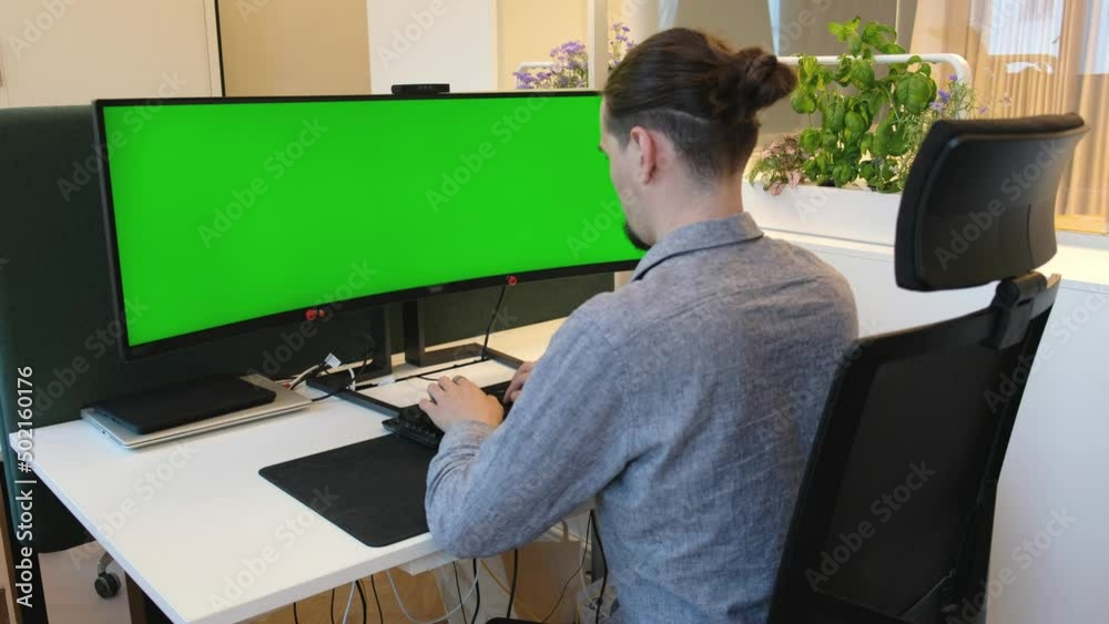 European male businessmen working and typing, view from a back ...