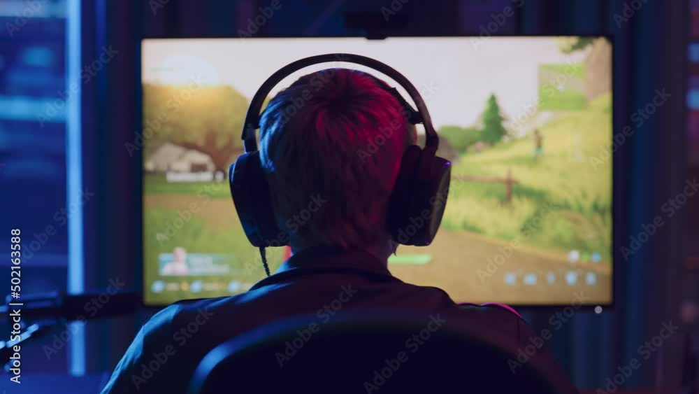 Back of the Head Angle of a Young Female Gamer Putting on Headphones ...