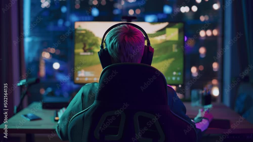 Back of the Head Angle of a Young Female Gamer Playing a Video Game on ...