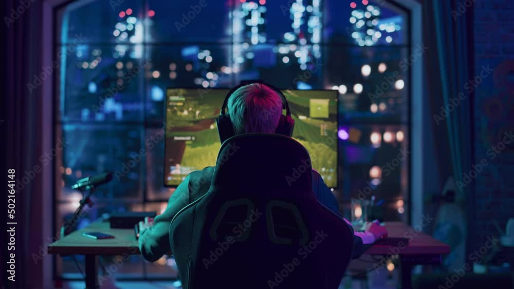 Back of the Head Angle of a Young Female Gamer Putting on Headphones ...