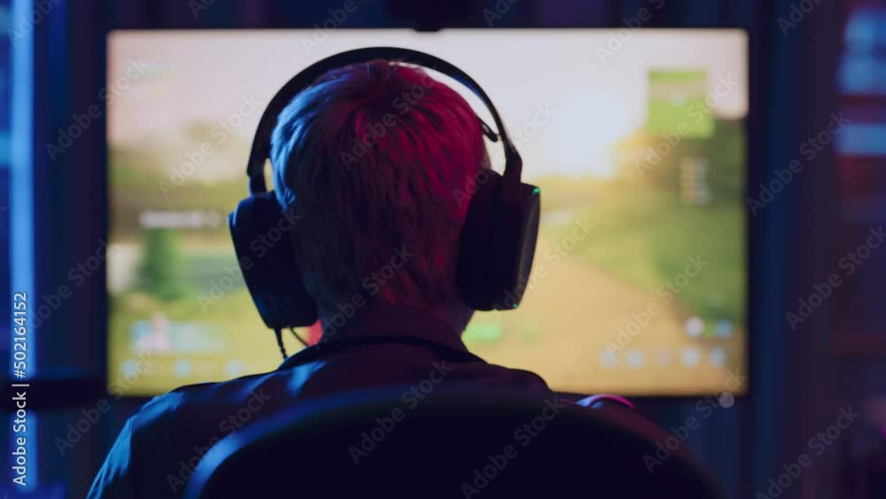 Back of the Head Angle of a Young Female Gamer Playing a Video Game on ...